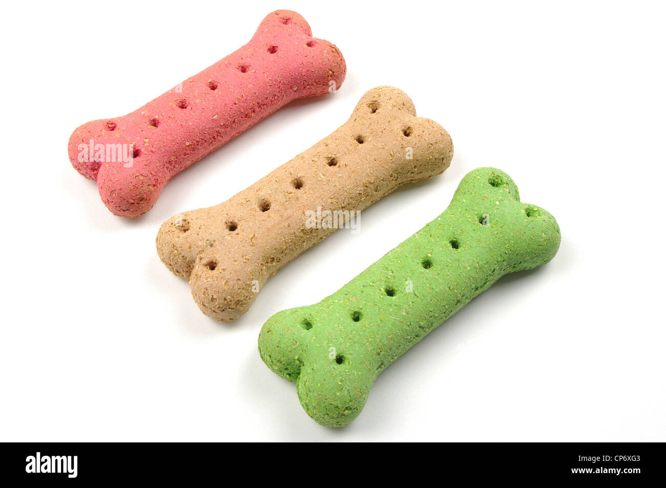 three coloured dog biscuits in a neat row Stock Photo - Alamy