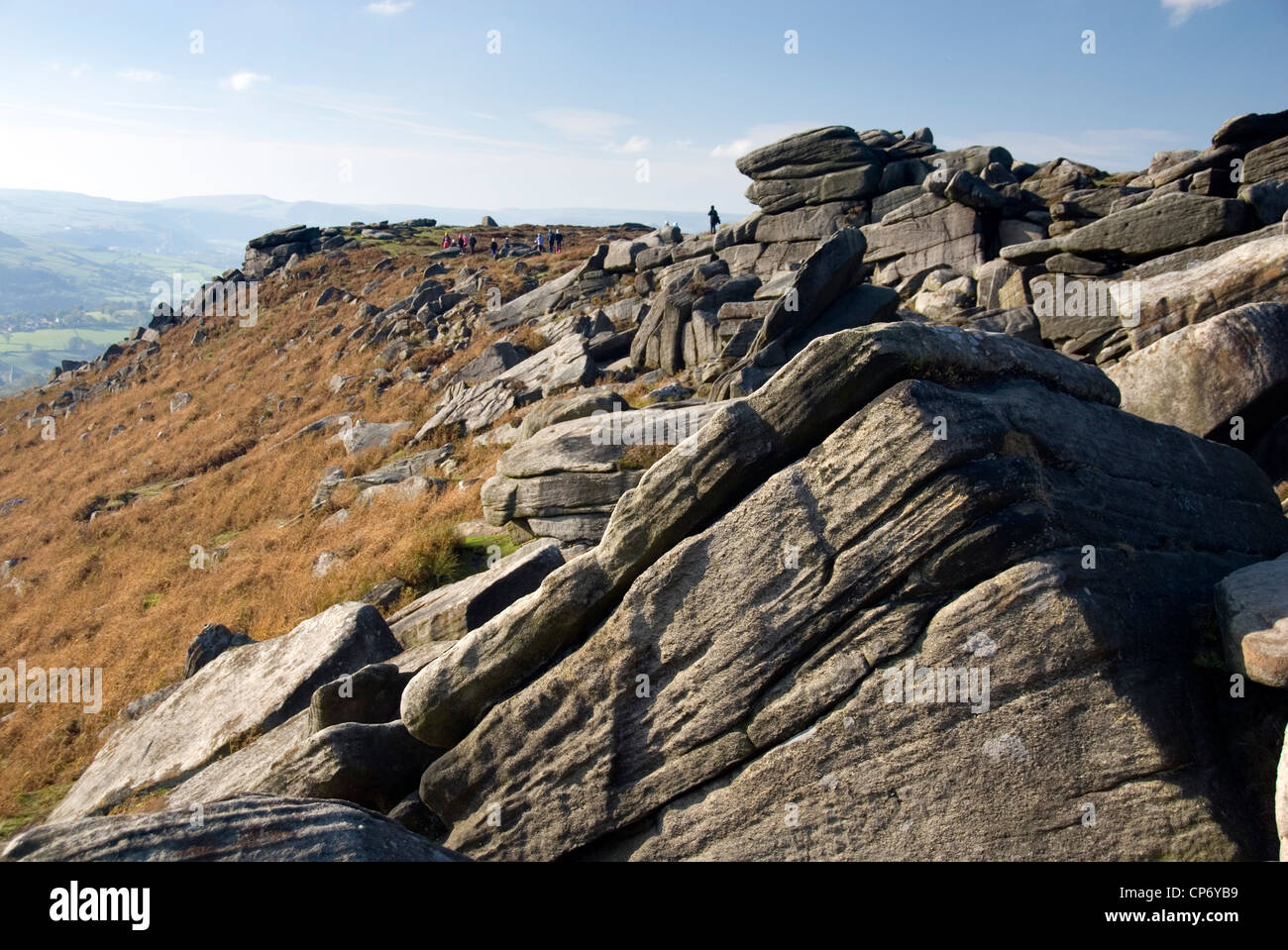 People Walking Along Crest of Stark Rocky Hillside of Higger Tor & View ...