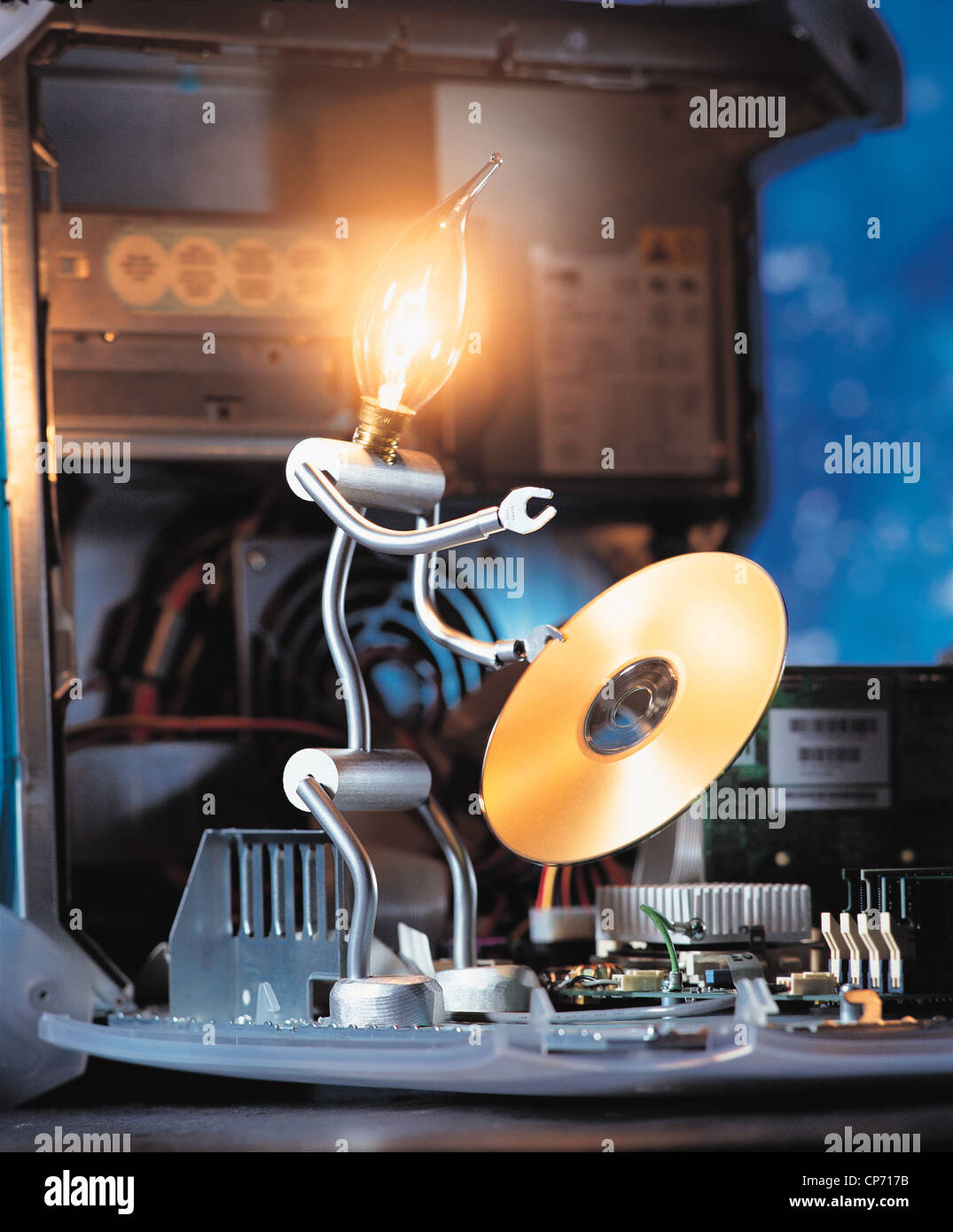 A little mechanical helper holding a CD Stock Photo - Alamy