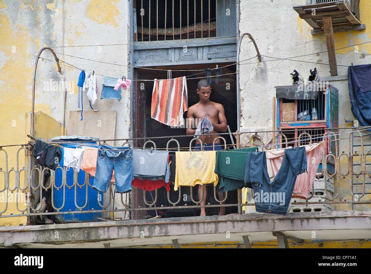 A man hanging out laundry on a balcony, Havana, Cuba Stock Photo - Alamy
