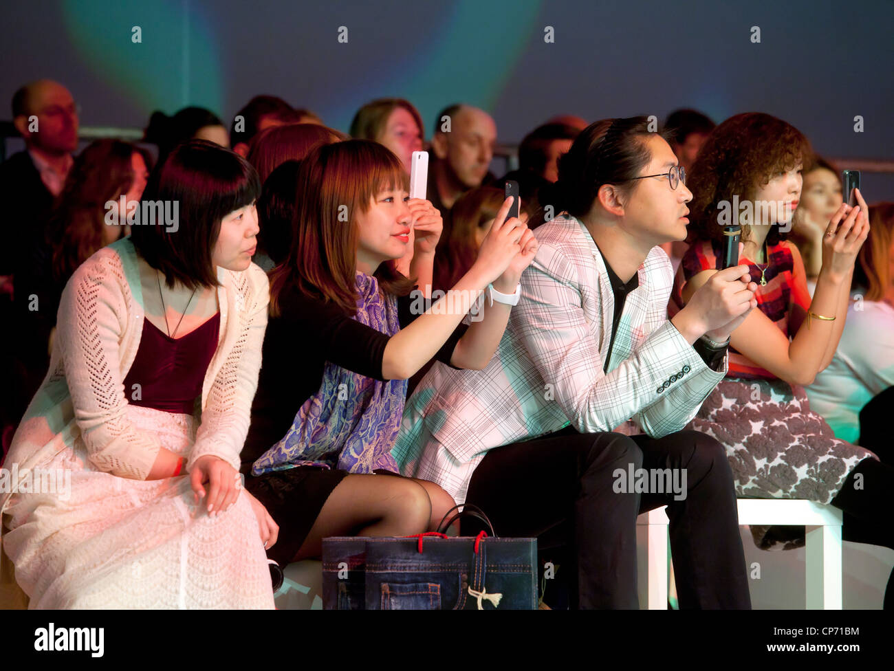 Spectators at the C&A fashion show admire autumn/winter fashion ...