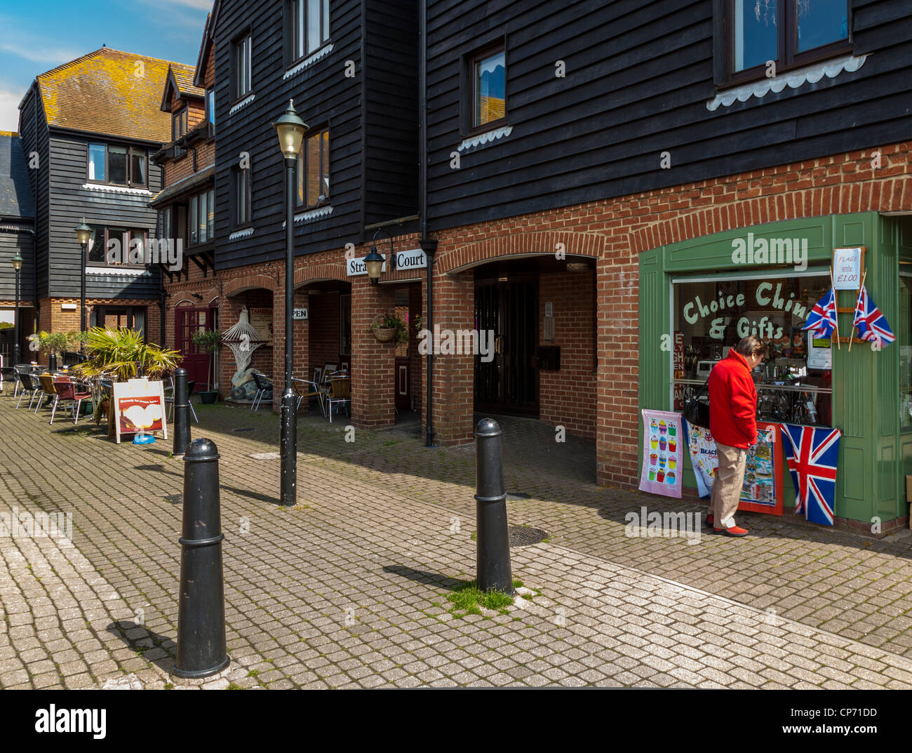 A tourist looking in a shop at Strand Court, Rye, East Sussex Stock ...