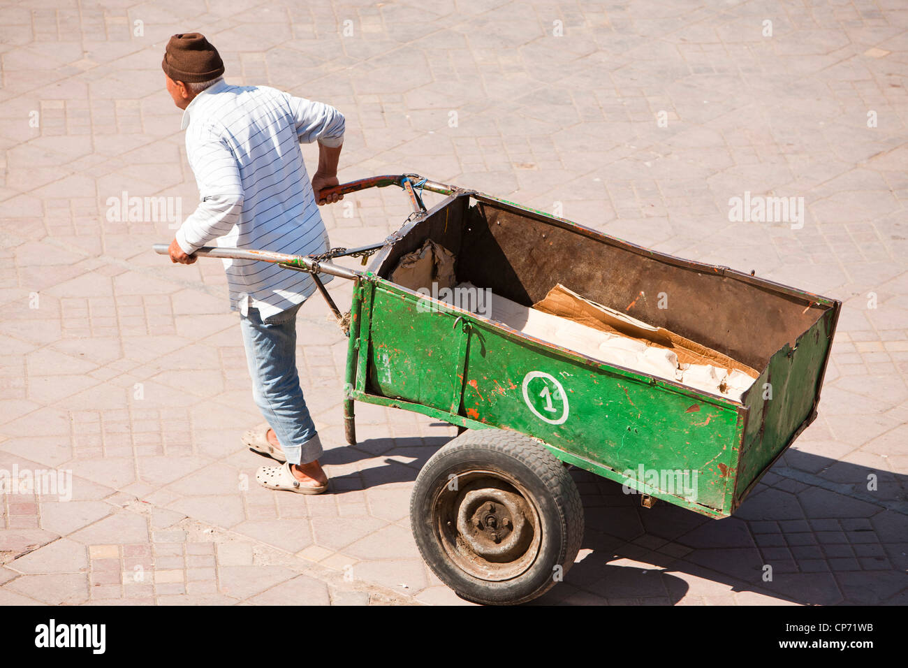 A man pulling a hand cart in Djemaa el Fna square in Morocco, North ...