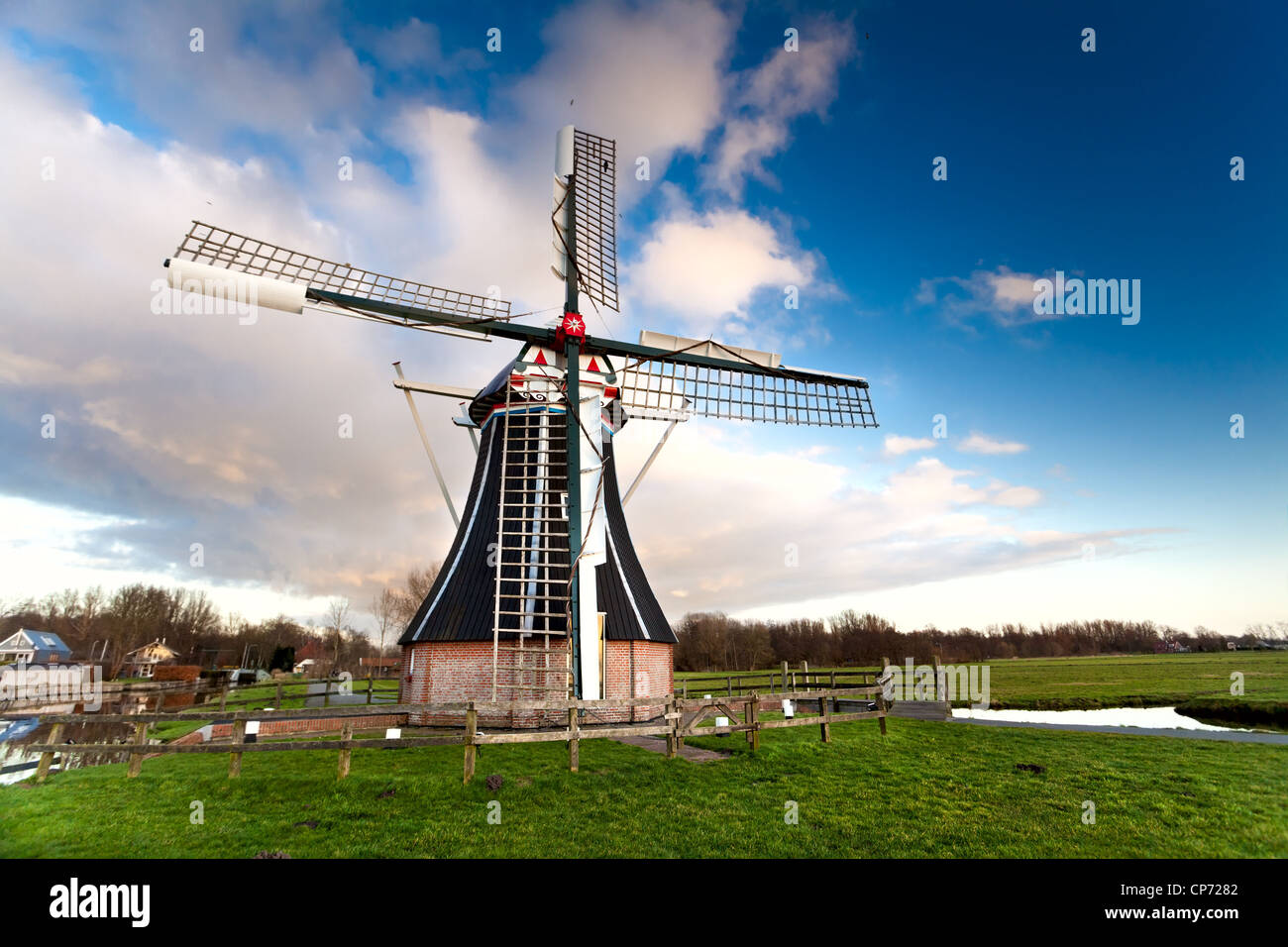 traditional Dutch windmill over blue sky with white clouds during a day ...