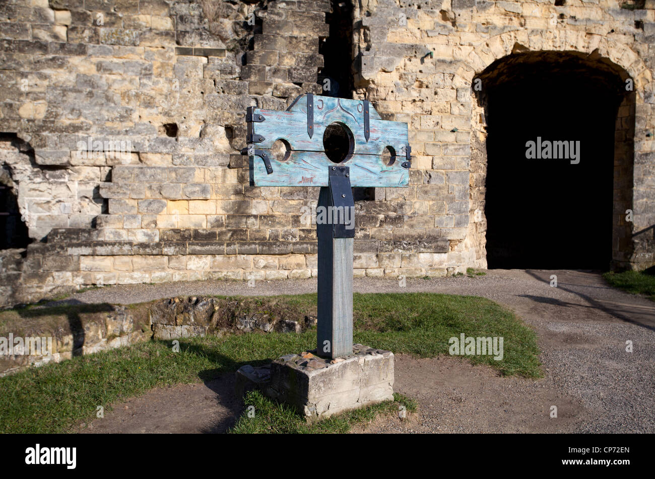 wooden guillotine in front of old castle stone wall Stock Photo - Alamy