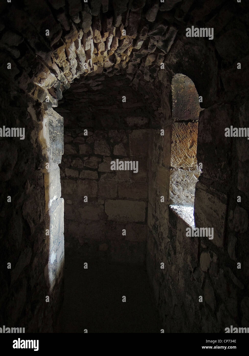 A stone archway illuminated by window in twelfth-century Conisbrough ...