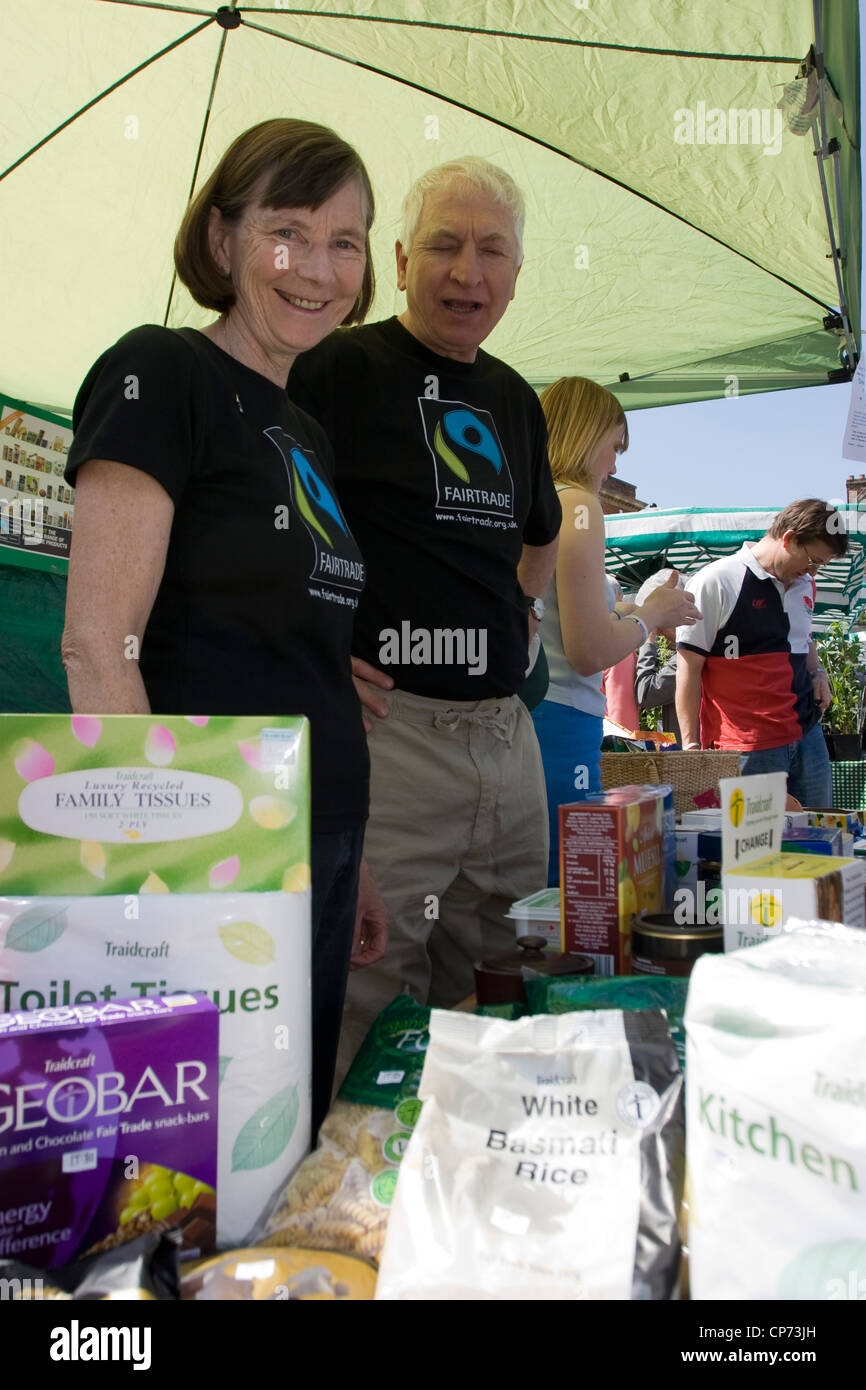 Volunteers promoting fair trade products on a market stall in Devizes ...