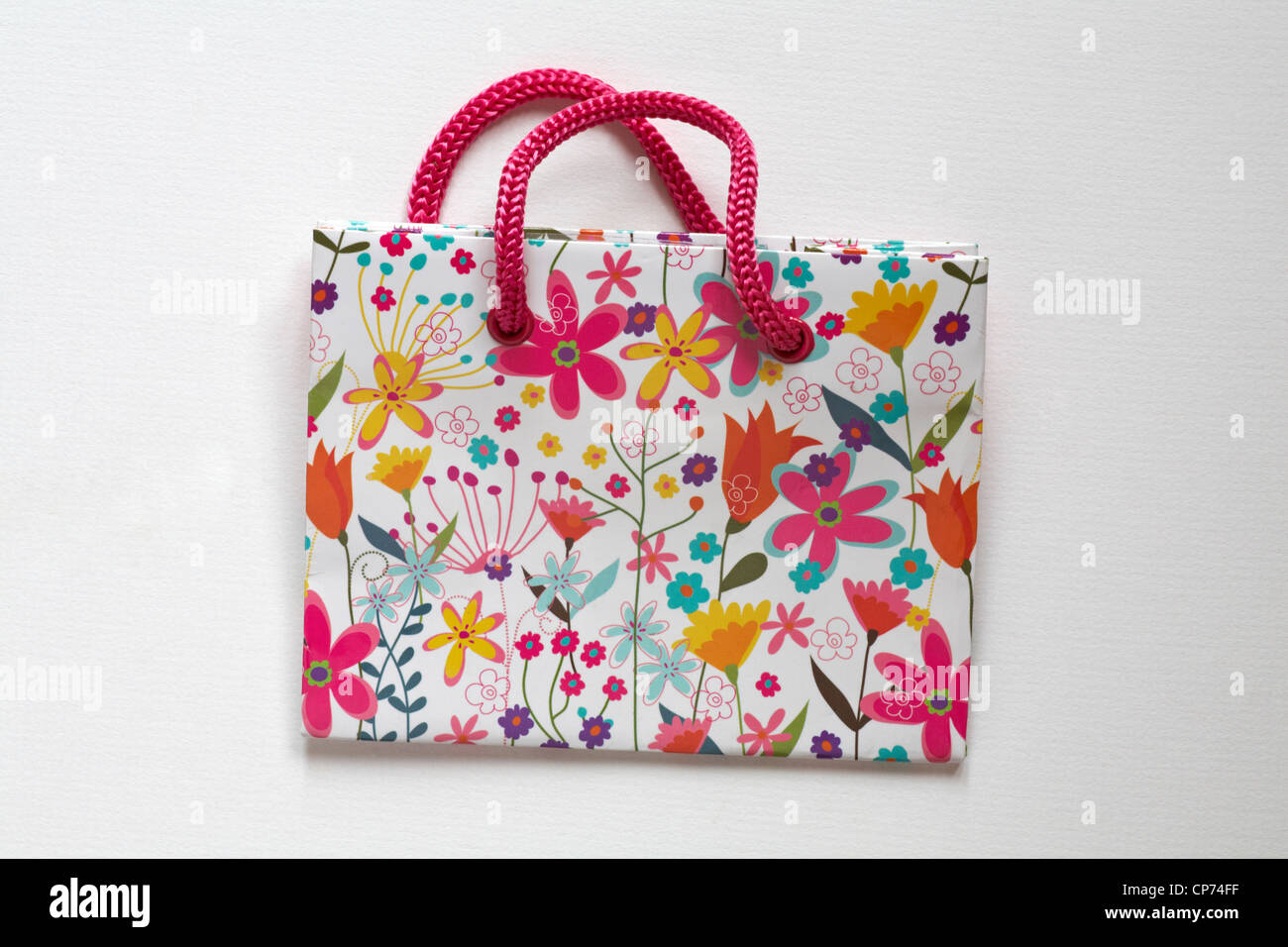 pretty floral gift bag with colourful flowers on isolated on white ...
