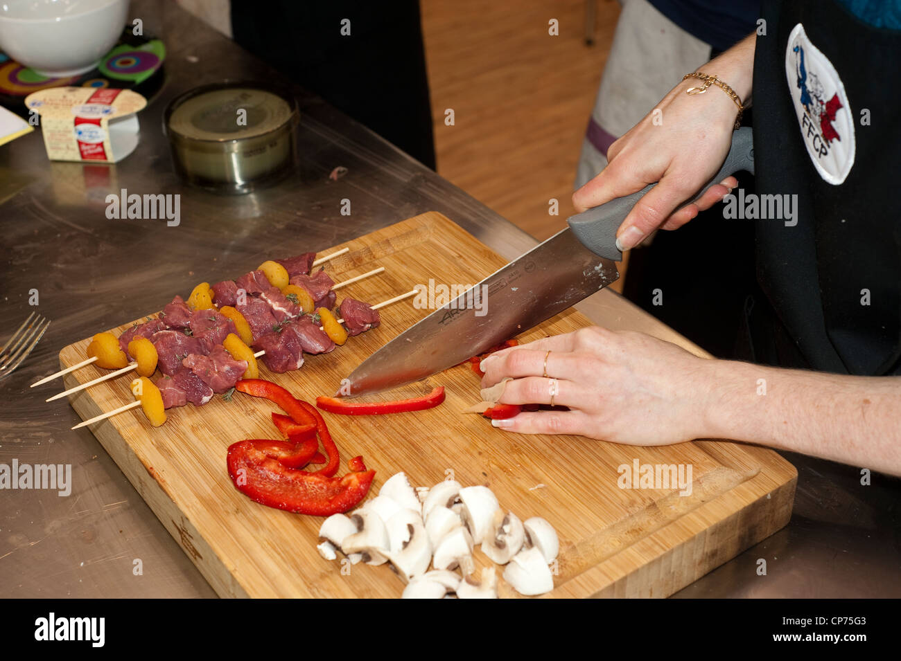 Paris, France - Woman cutting red peppers during cooking class Stock ...
