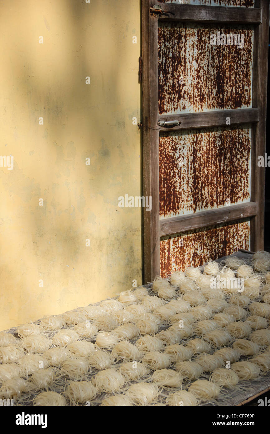 Rice noodles drying on the table outside in Vietnam Stock Photo - Alamy