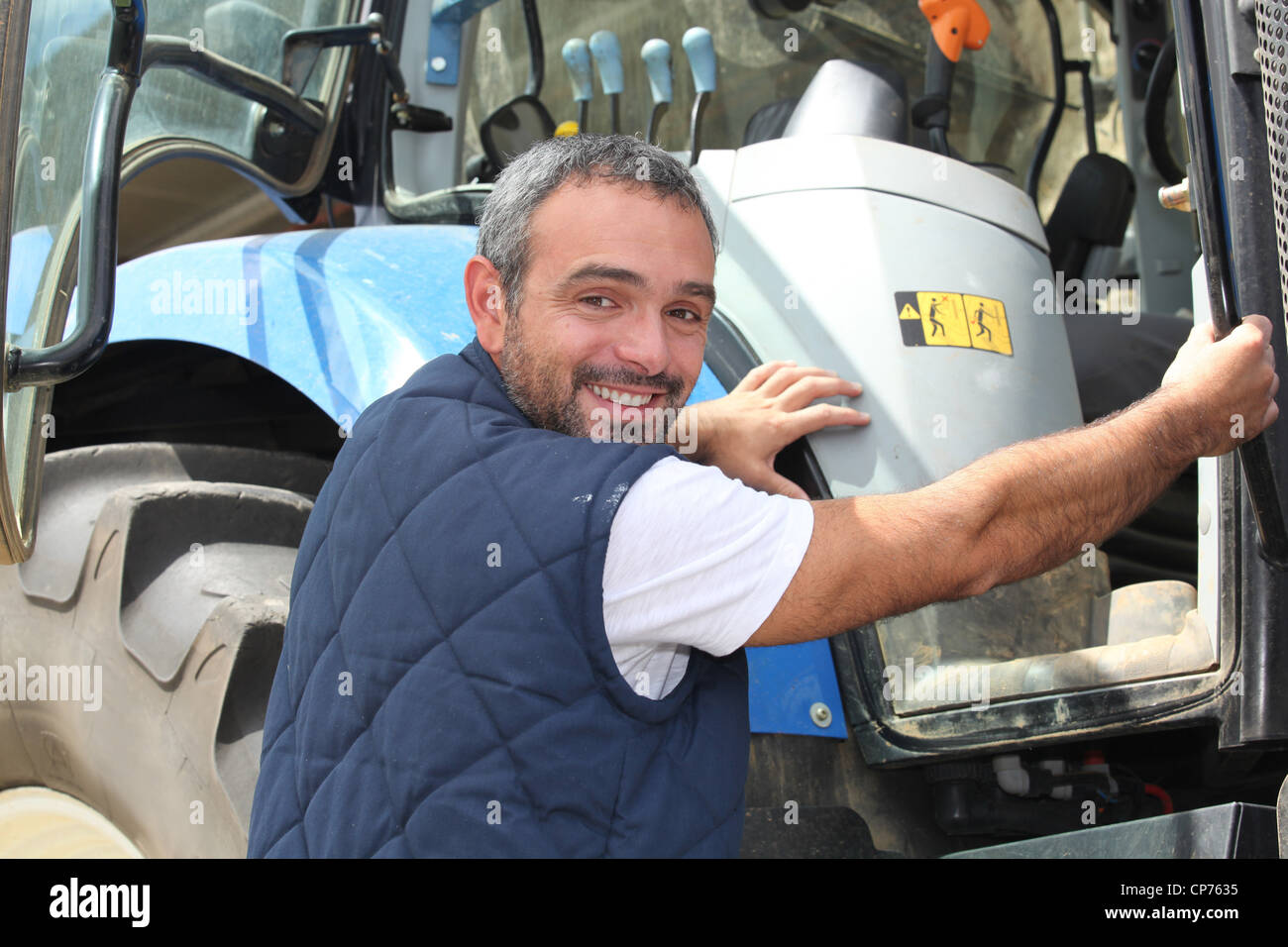 Farmer climbing tractor hi-res stock photography and images - Alamy