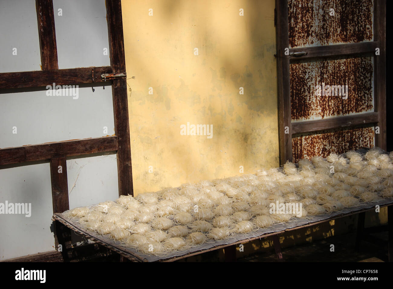 Rice noodles drying on the table outside in Vietnam Stock Photo - Alamy