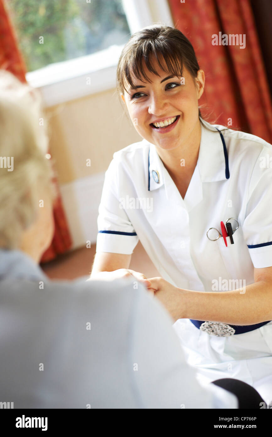 District nurse giving advice on home visit Stock Photo - Alamy