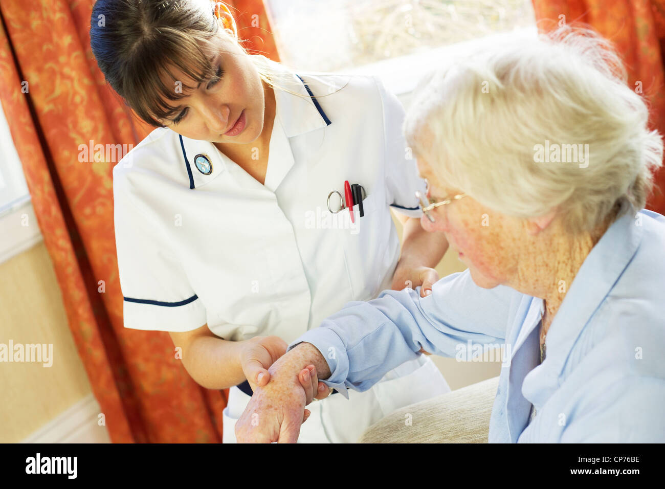 District nurse giving advice on home visit Stock Photo - Alamy
