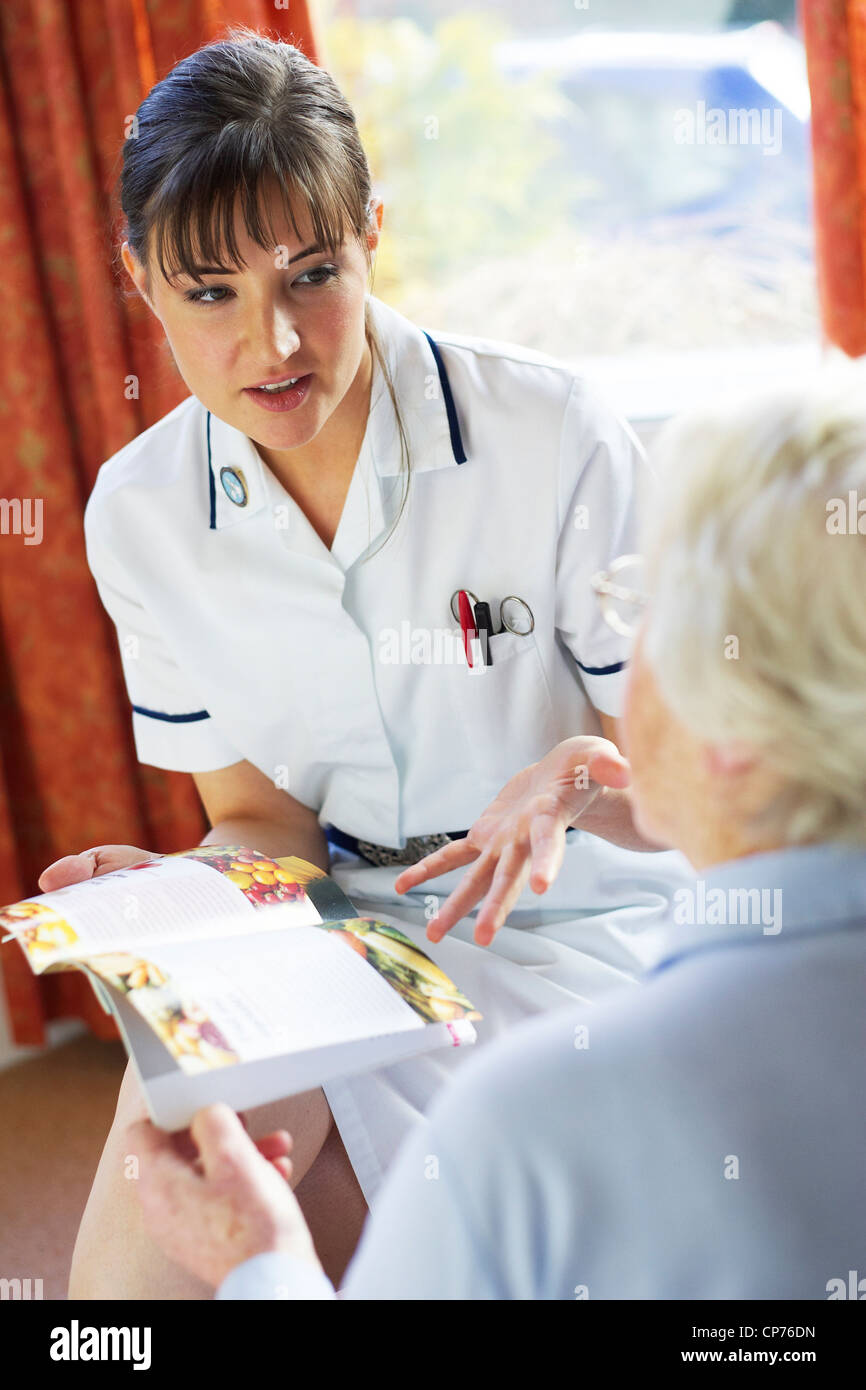 District nurse giving advice on home visit Stock Photo - Alamy