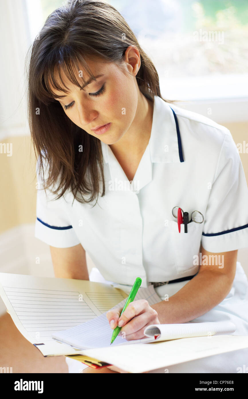Nurse writing details Stock Photo - Alamy