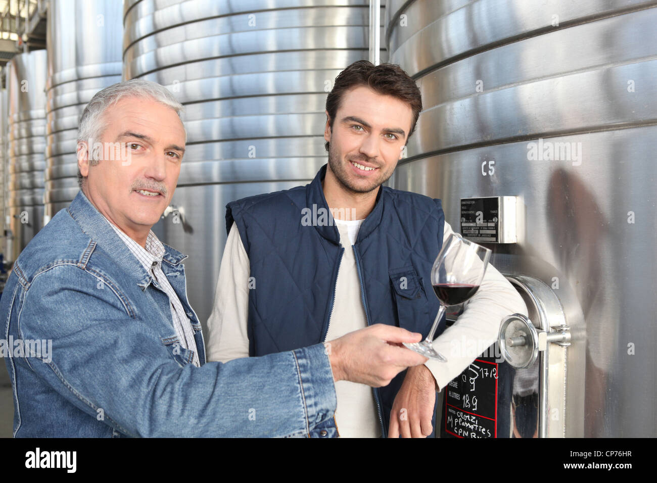 Men in a modern winemaking facility Stock Photo - Alamy
