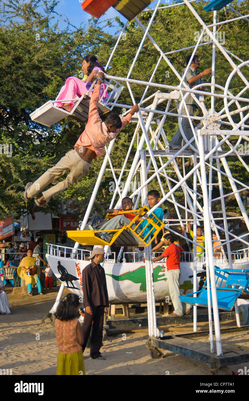 A man powers a motorless ferris wheel by climbing to the top, hanging ...