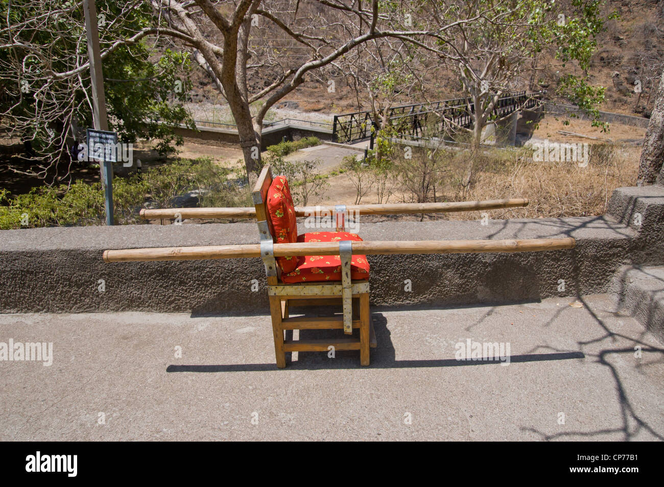 A chair (carried by two people) can transport a person around the ...