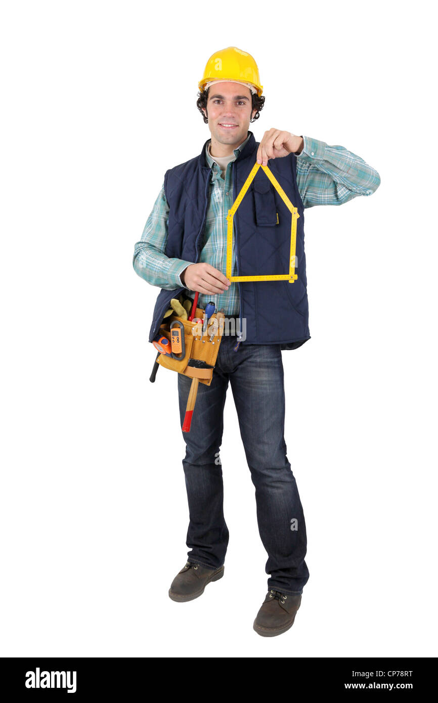 Man holding tool in shape of house Stock Photo - Alamy