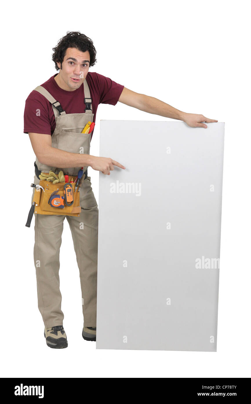Carpenter pointing to a blank board Stock Photo - Alamy