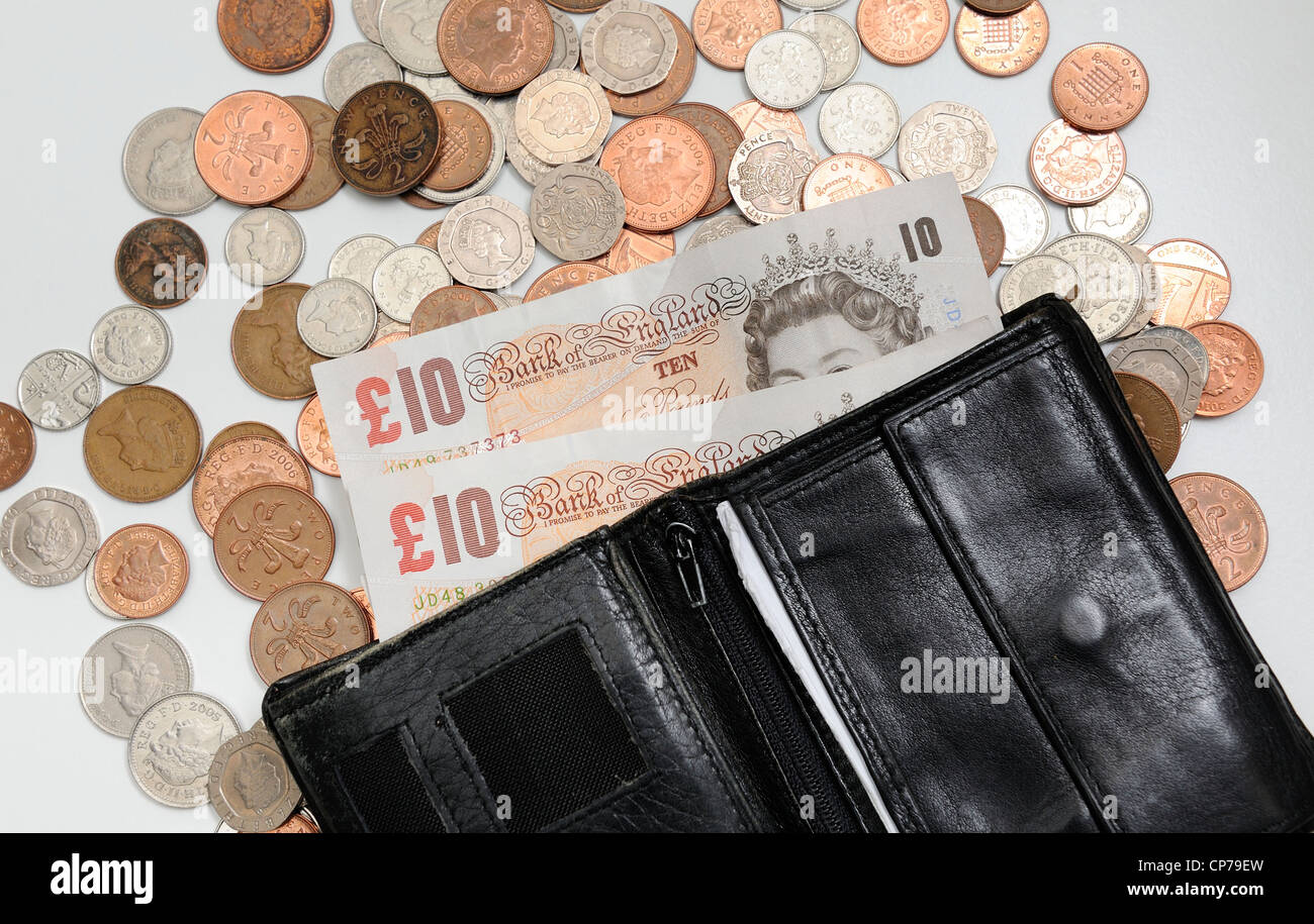 English notes and currency and a black wallet Stock Photo - Alamy