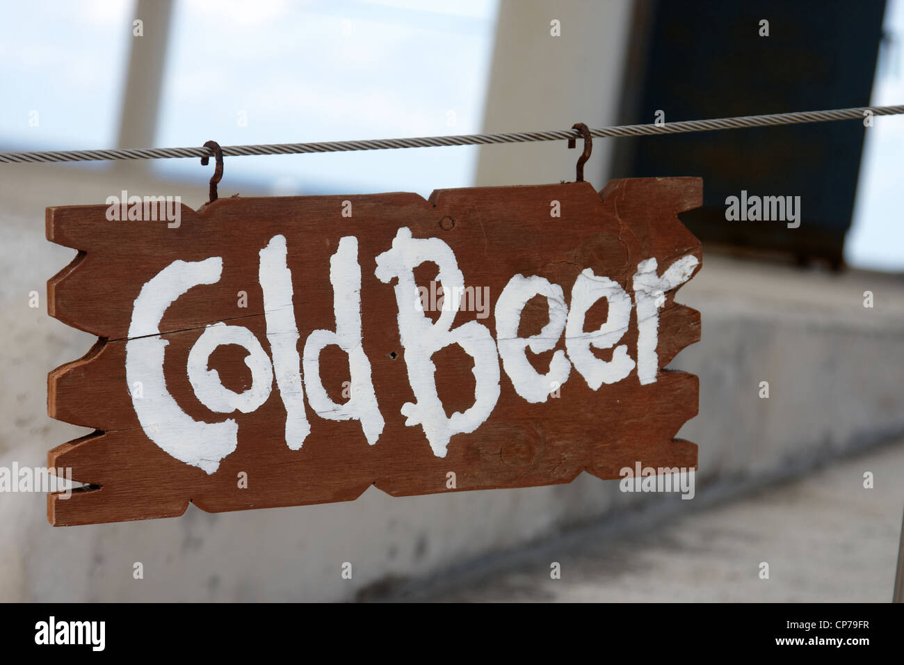 Cold Beer sign attached to a wire with hooks Stock Photo - Alamy