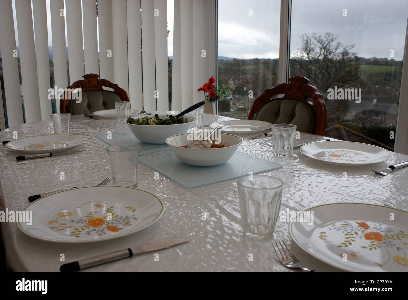 A dining table, set for food with plates knives and forks Stock Photo ...