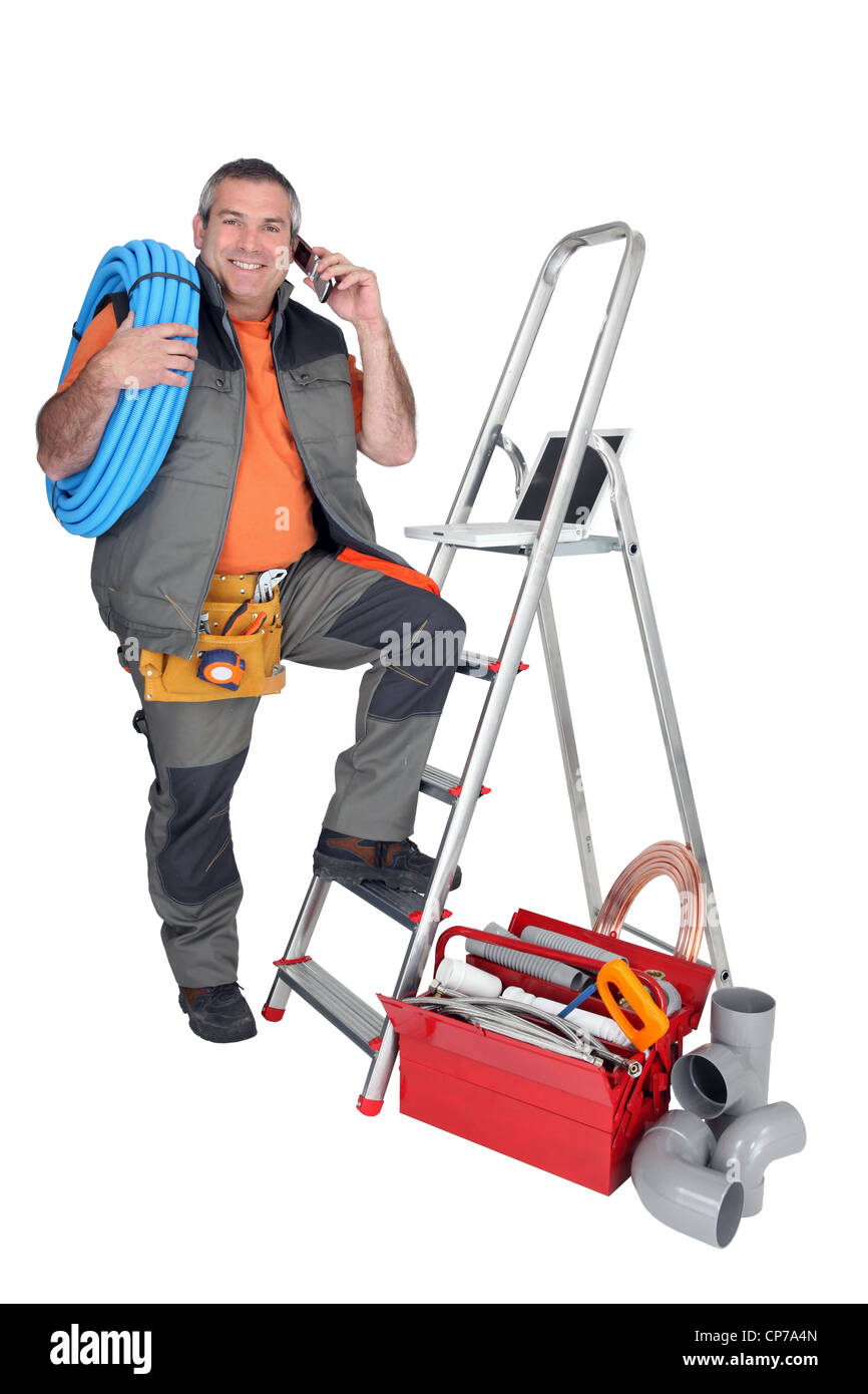 plumber on the phone next to stepladder with laptop Stock Photo - Alamy