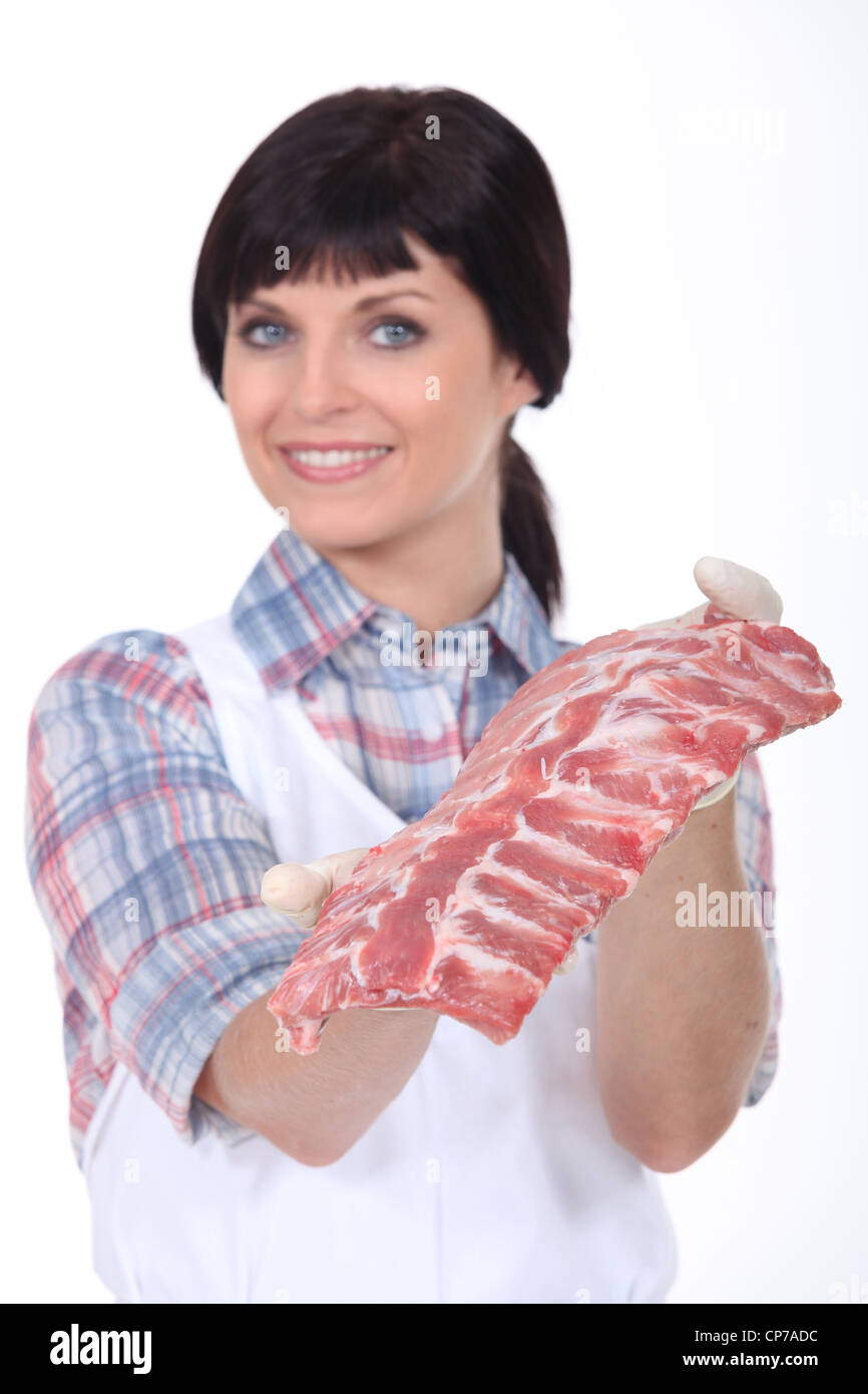 Female butcher stood with raw meat Stock Photo - Alamy