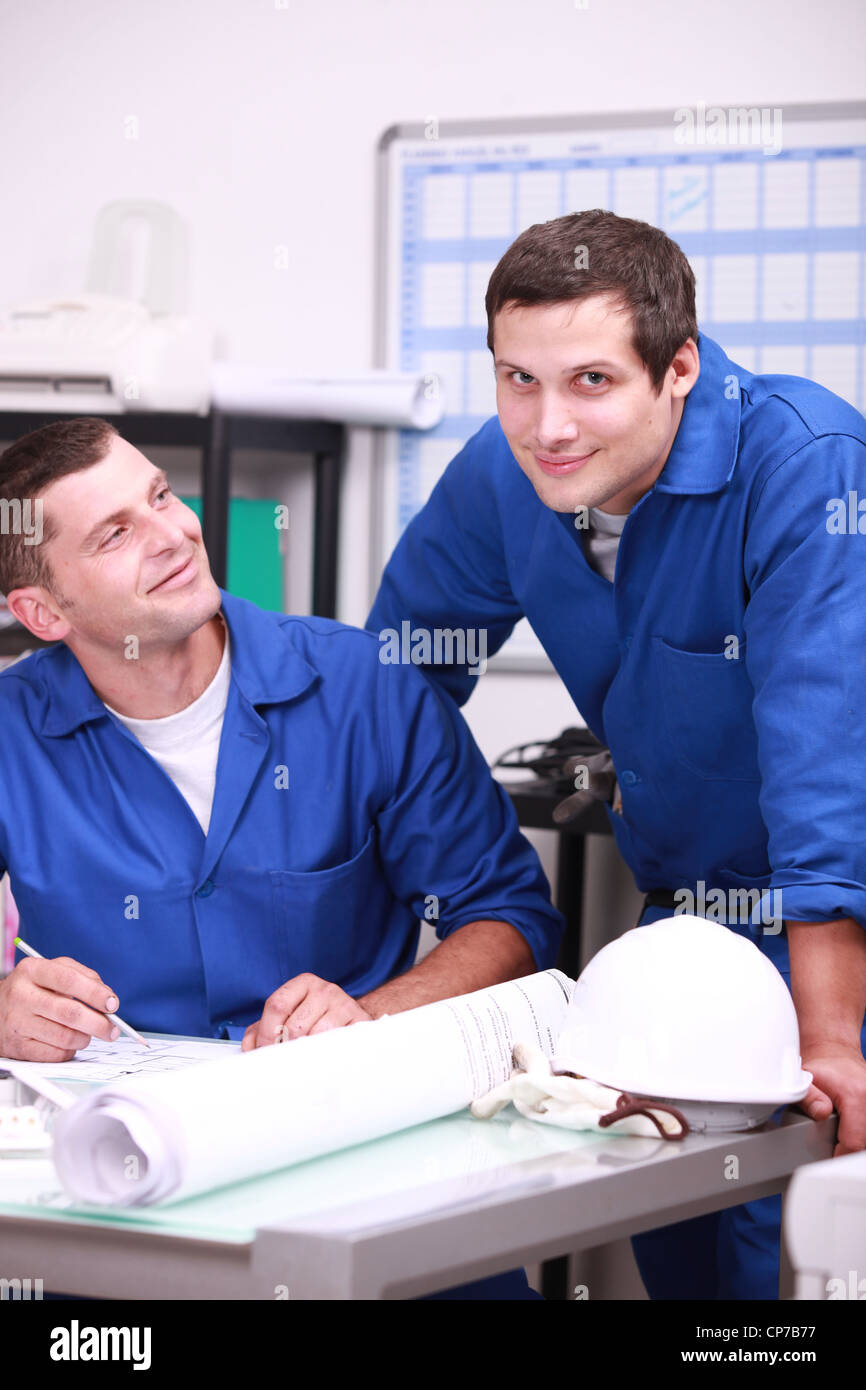 Two factory workers in the office checking stock Stock Photo - Alamy