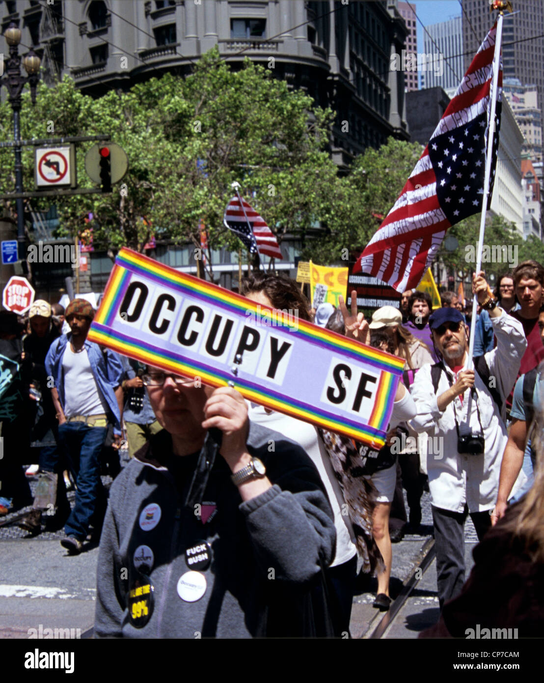 Occupy San Francisco marchers hold signs and upside down American flags ...