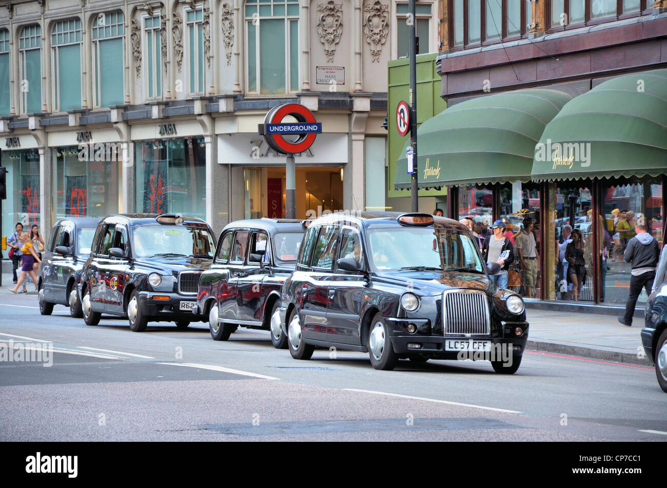 Queue of taxis on the street in London Stock Photo - Alamy