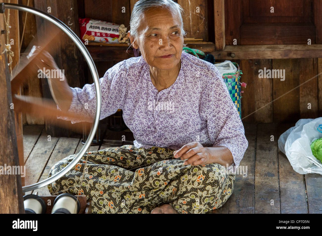 Woman working on a spinning wheel, Inle Lake, Myanmar Stock Photo - Alamy