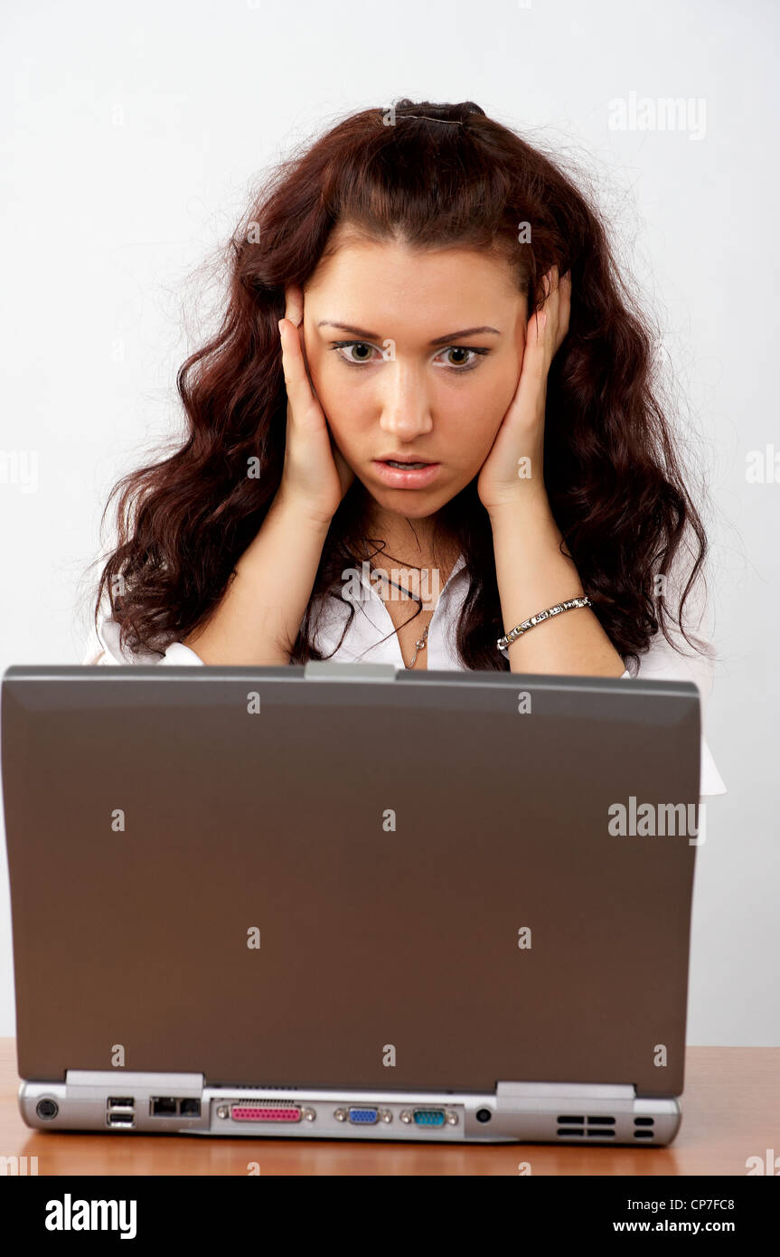 Portrait of beautiful young business woman at her desk, looking ...