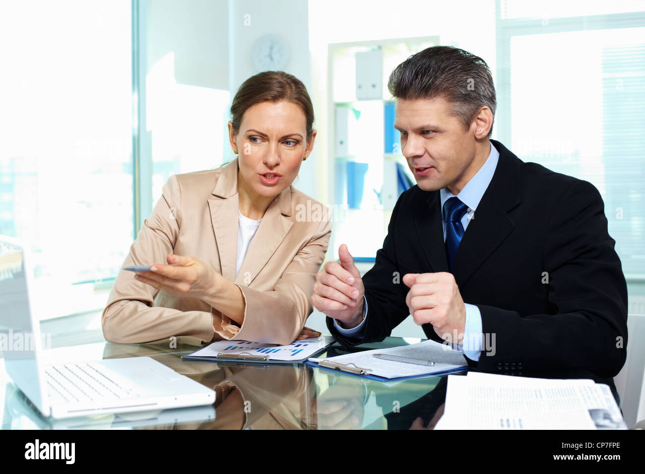 Business partners discussing possible options in terms of a new ...