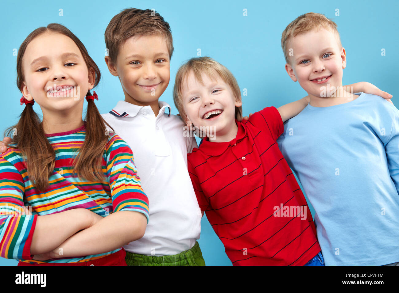Group portrait of four smiling friends hugging Stock Photo - Alamy