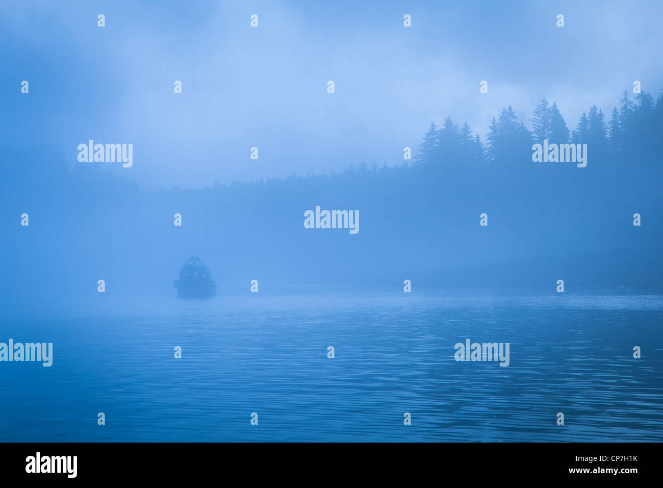 View of commercial fishing boat through thick fog, Bartlett Cove ...