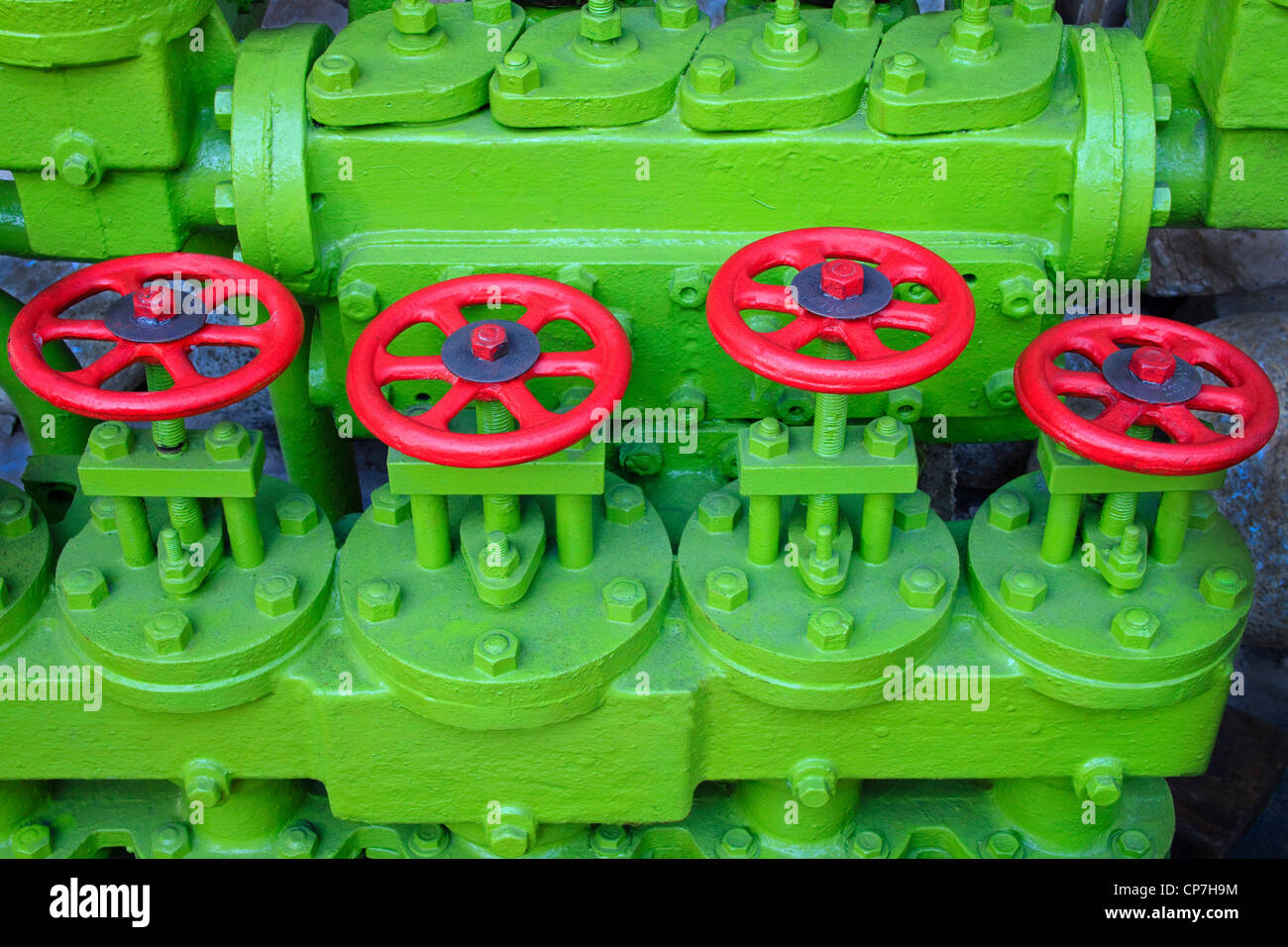 Green painted engine with red painted round handled valve controls ...