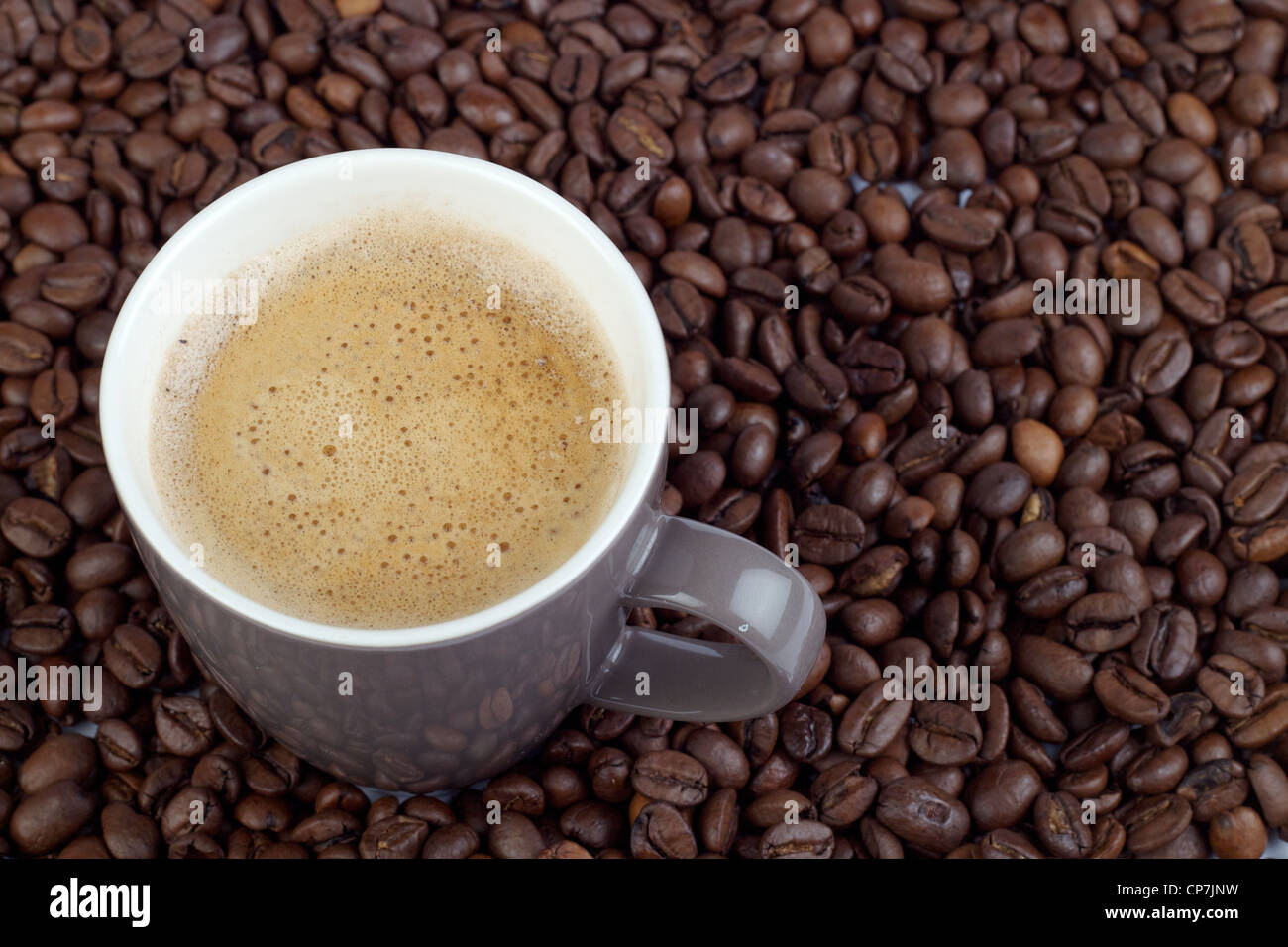 High resolution file full of coffee beans with a cup full of coffee on ...