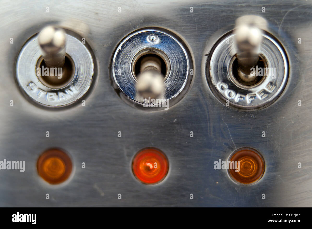 steam on and coffee switches on a retro or vintage old espresso machine ...