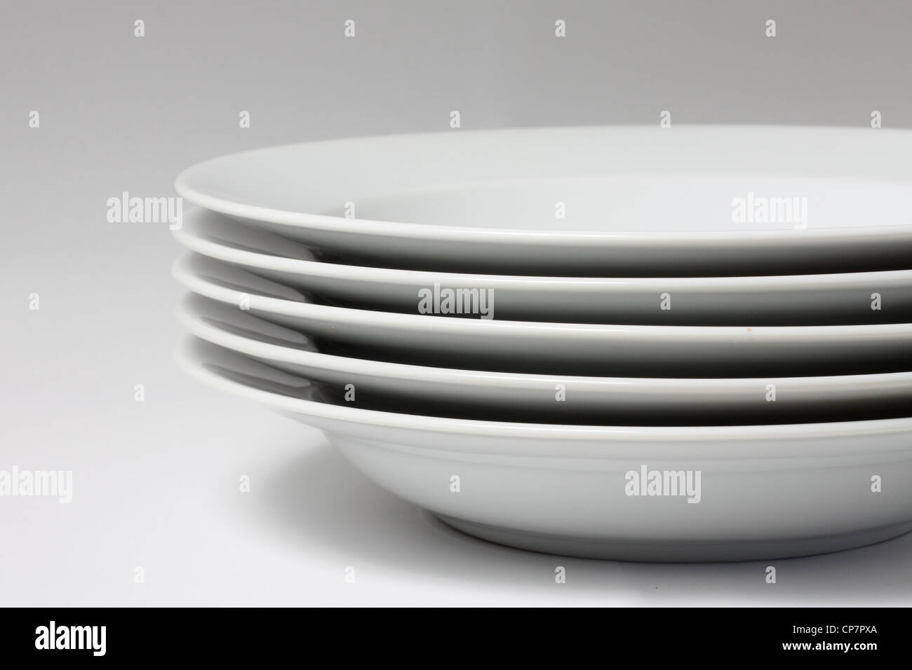 Plates in a stack shot in a studio Stock Photo - Alamy