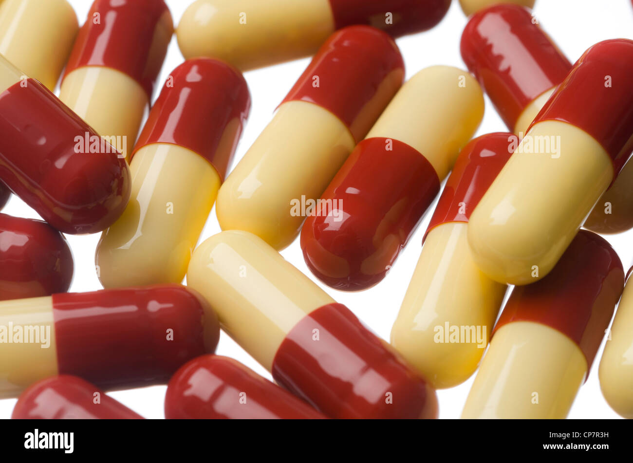 Shiny red and yellow medical capsule pill tablets Stock Photo - Alamy