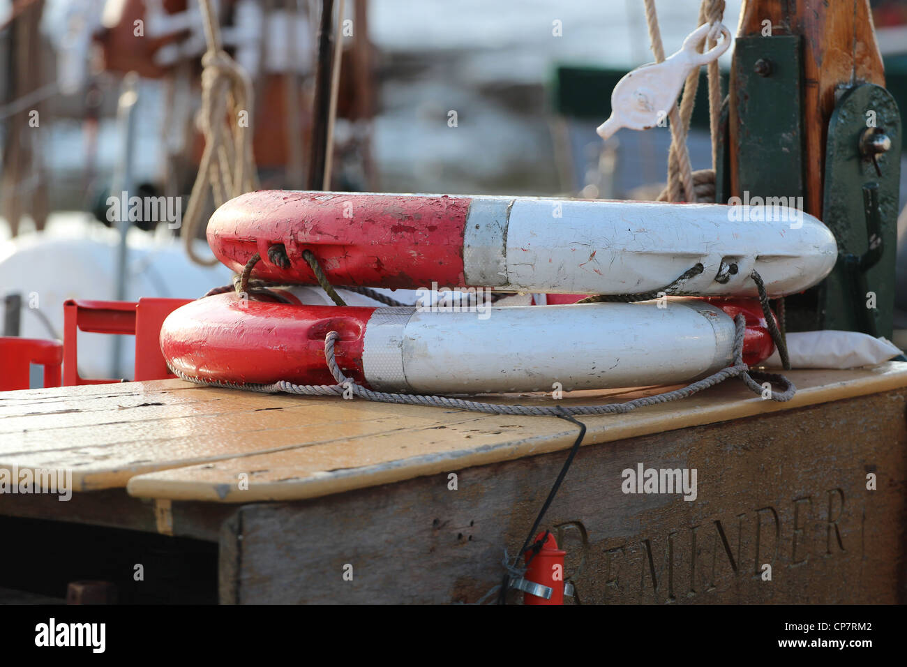 Two red and white lifebuoys on the deck of a boat Stock Photo - Alamy