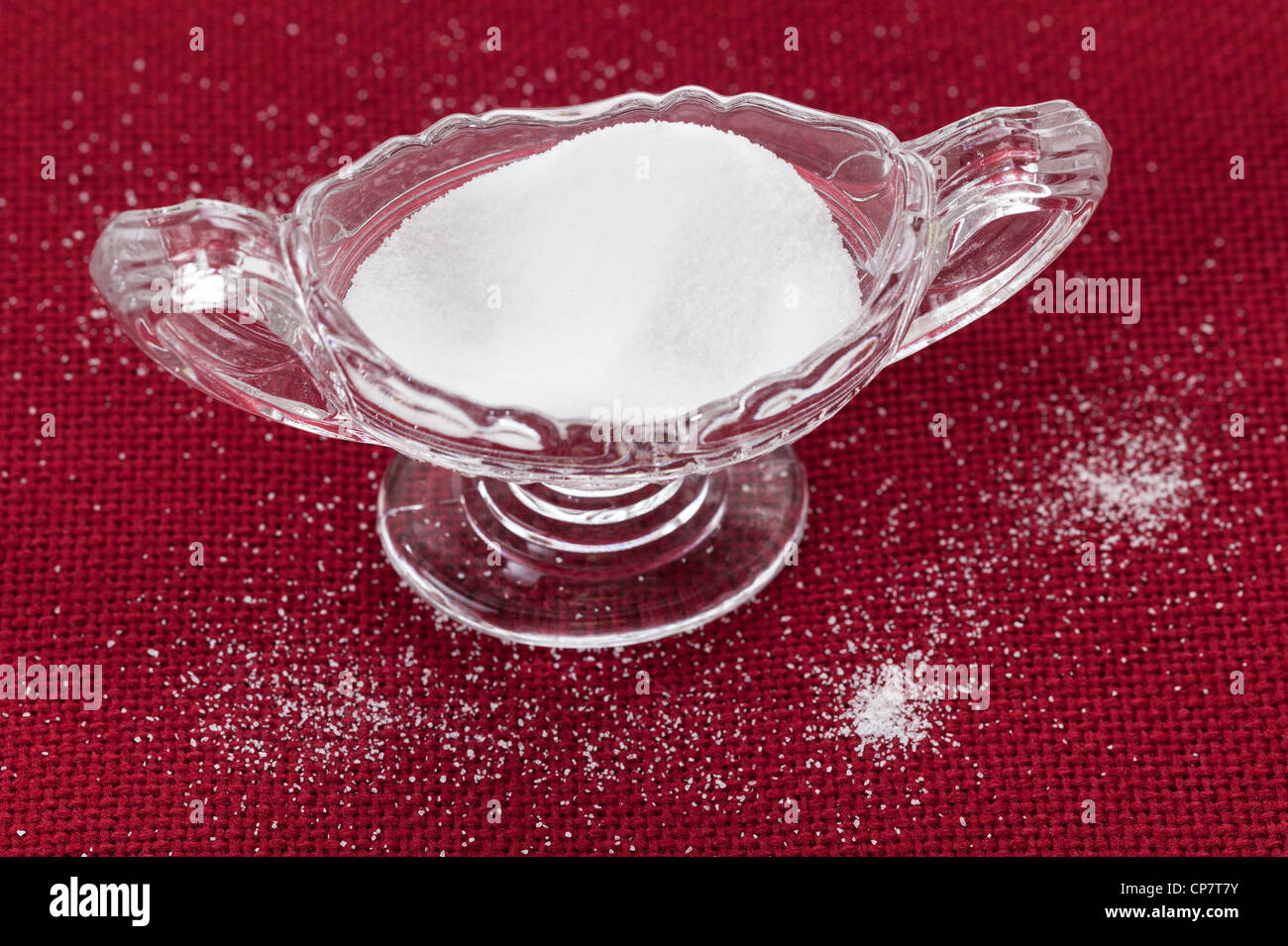 Table salt crystals in cut glass bowl on red tablecloth Stock Photo - Alamy