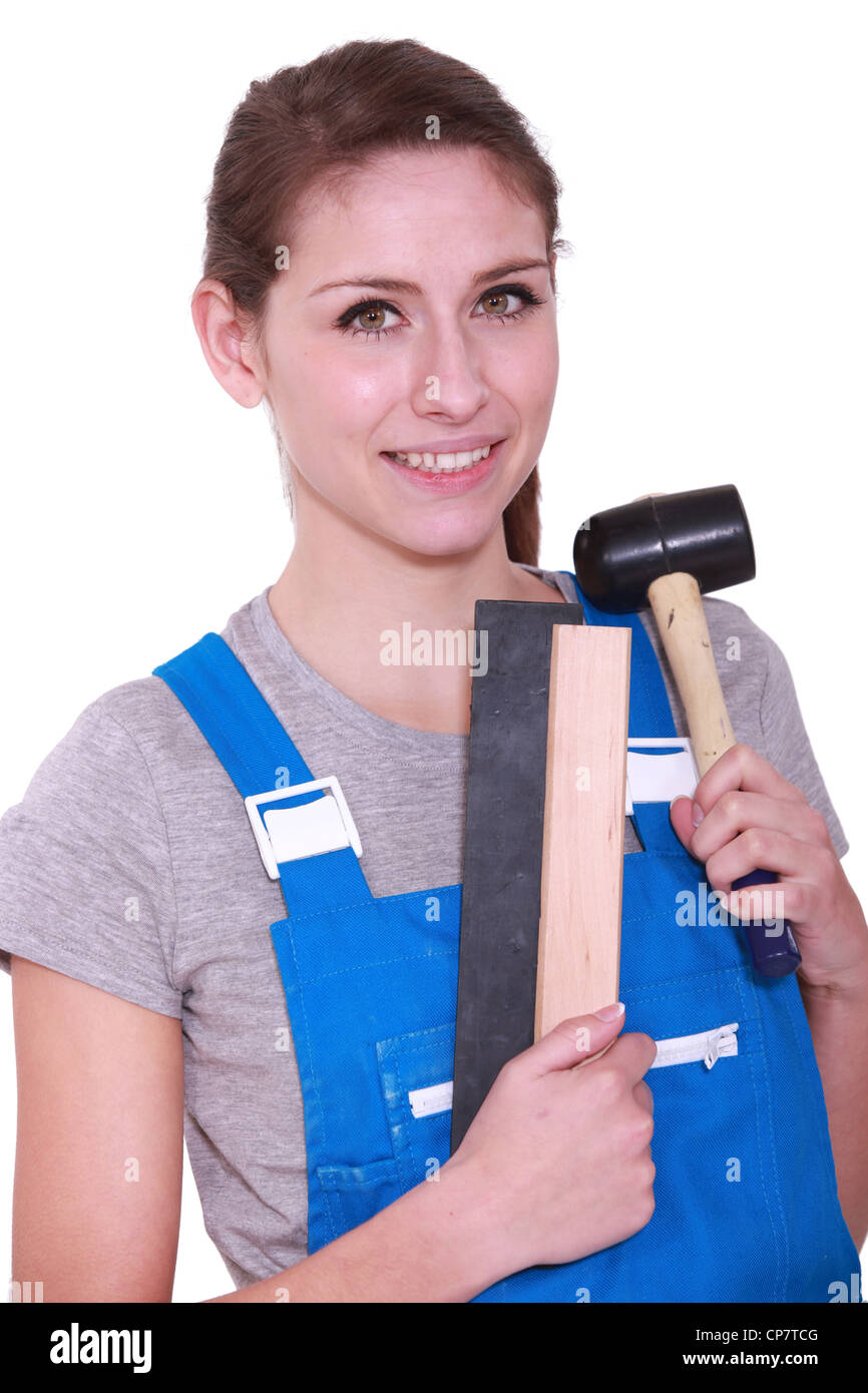 Female labourer holding mallet and sand paper Stock Photo - Alamy