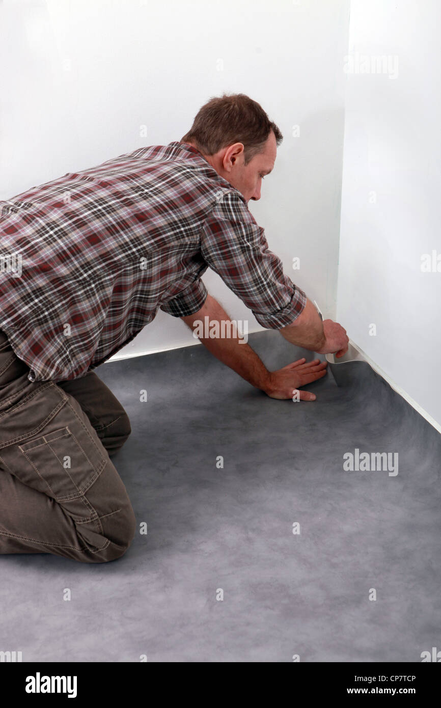 Man laying carpet Stock Photo - Alamy