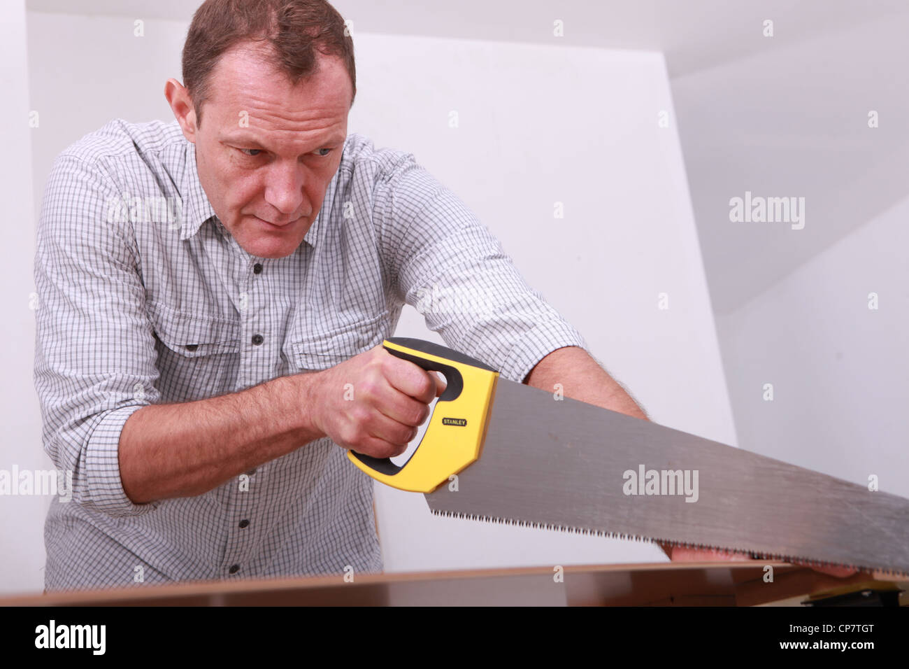 Handyman with hand saw Stock Photo - Alamy