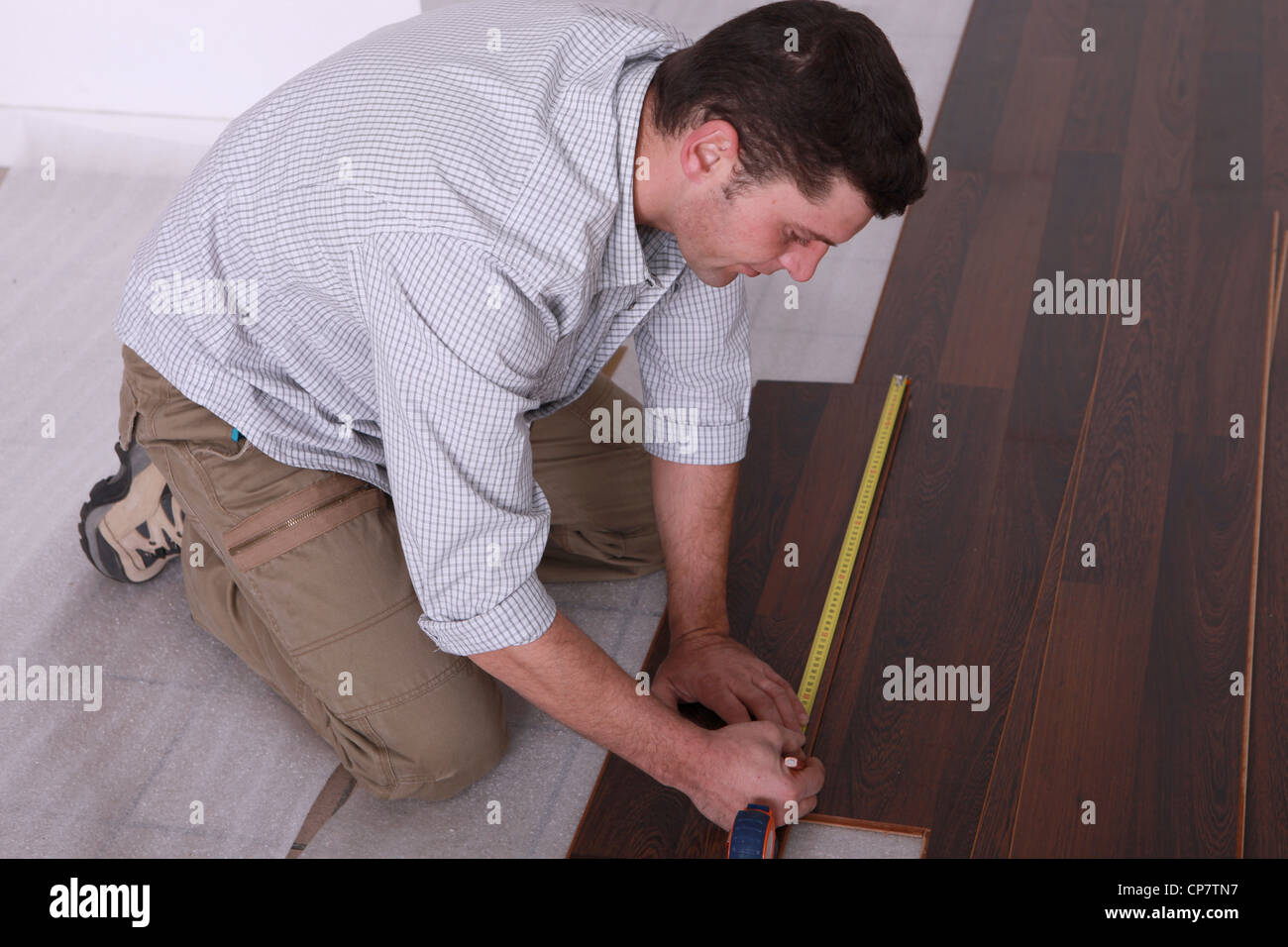 Man using a measuring tape Stock Photo - Alamy