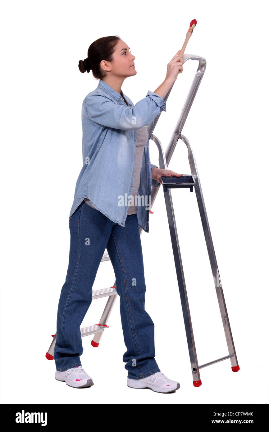 Female decorator stood by step-ladder Stock Photo - Alamy